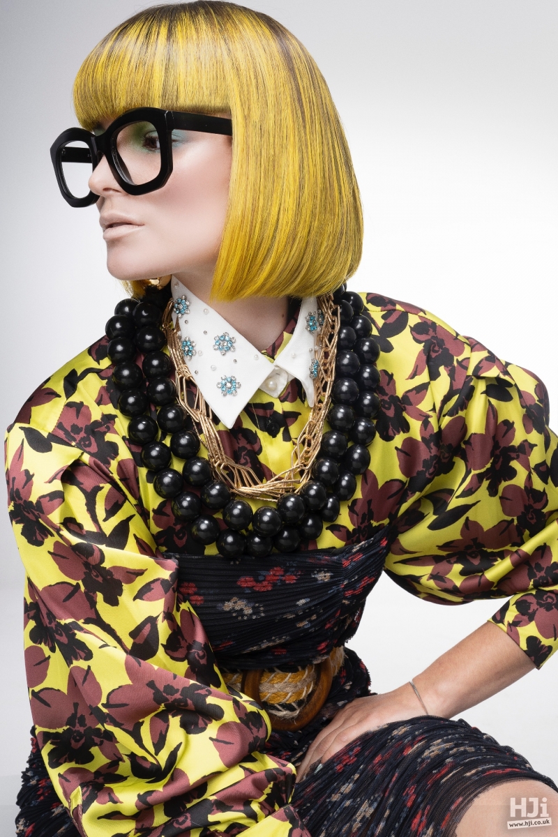 A bright yellow bob with strong, brunette roots and a block fringe