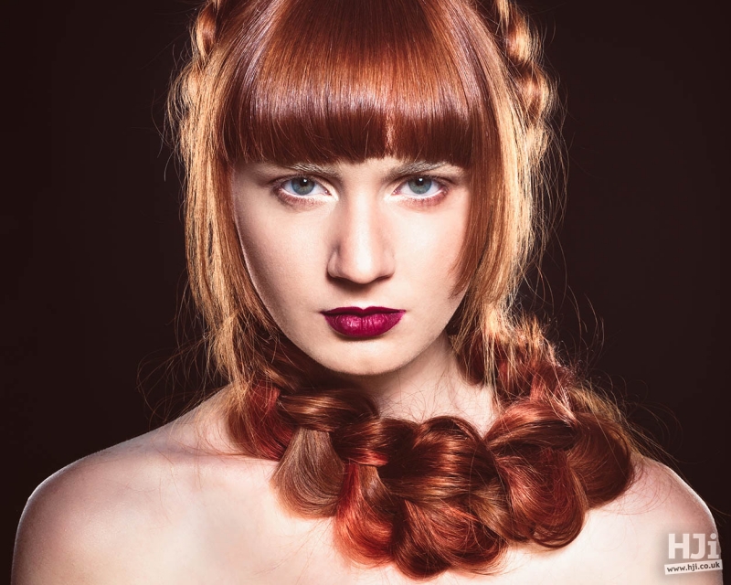 Creative plaiting in shiny red hair
