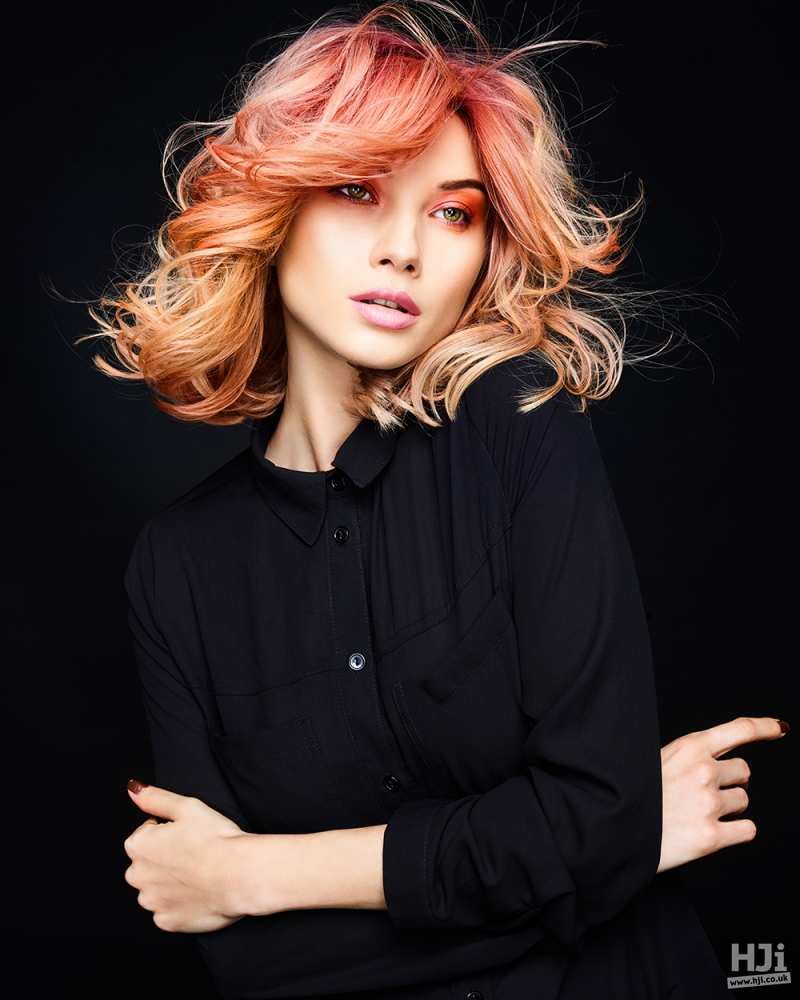 Peach coloured curly bob