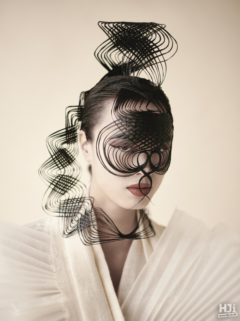 Natural black hair in zig-zag geometric fold patterns