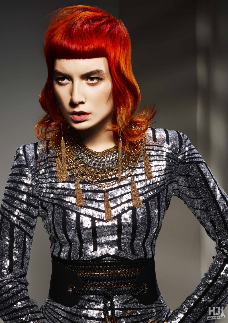 Bright red and orange mid length cut with fringe