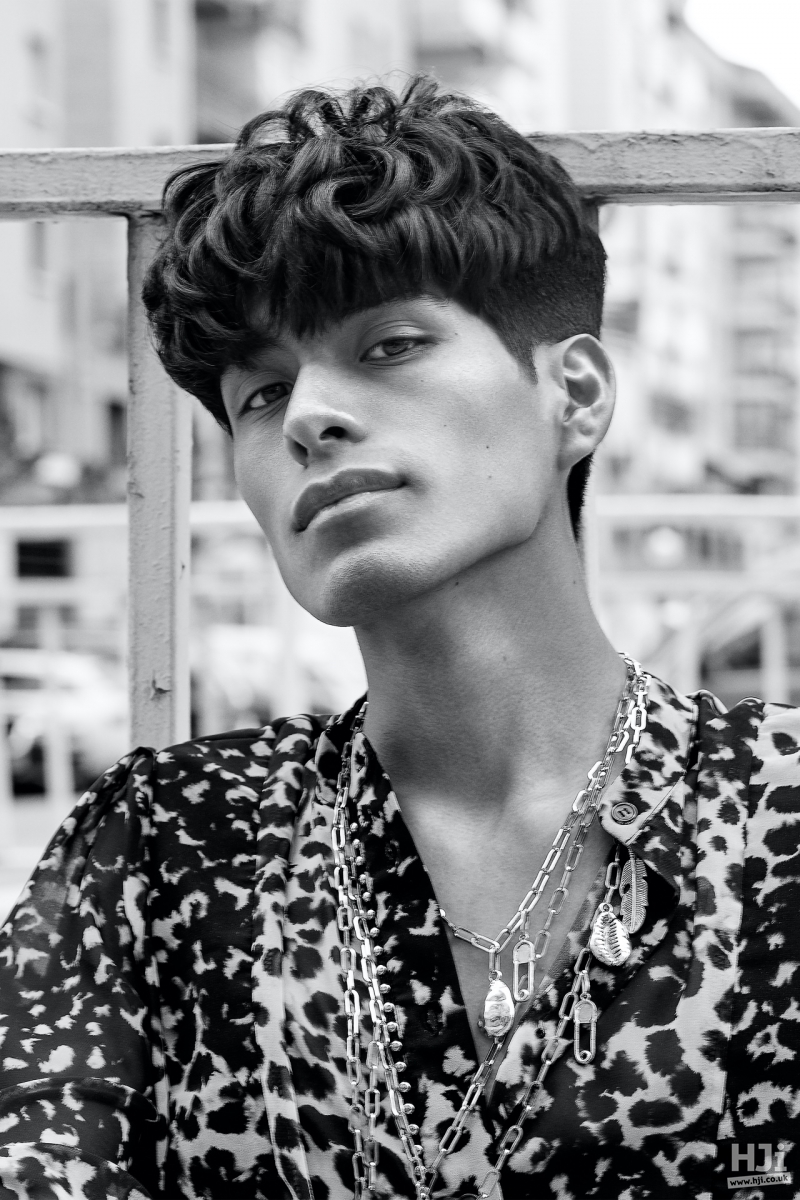 Short men's hair with fluffy layers and blunt fringe